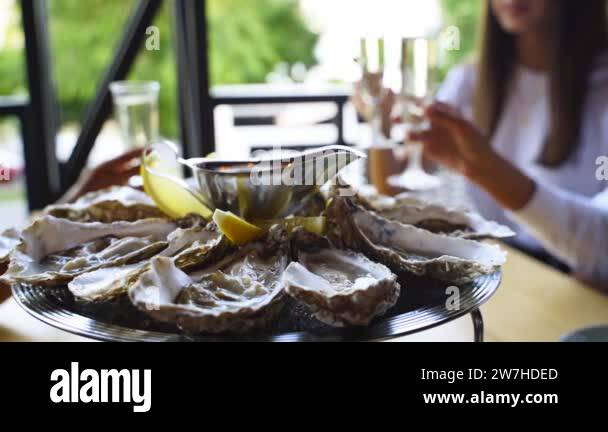 Luxury restaurant visitors clinking glasses with wine and cheering ...