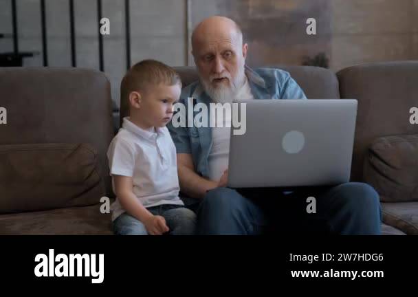Elderly old man father grandfather talking with young grandson ...