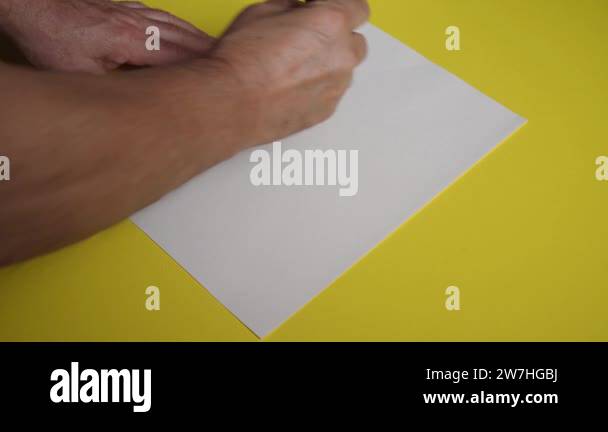 a man draws a question mark with a marker on a blank sheet of paper ...