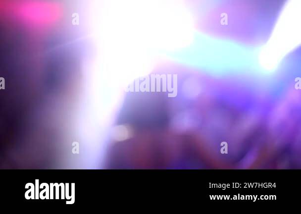 Neon lights on the dance floor. Slow time. Blurry bokeh. People are ...