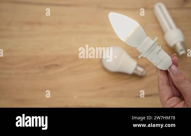 electricity, modern electric lamp in hand is lit on the background of ...