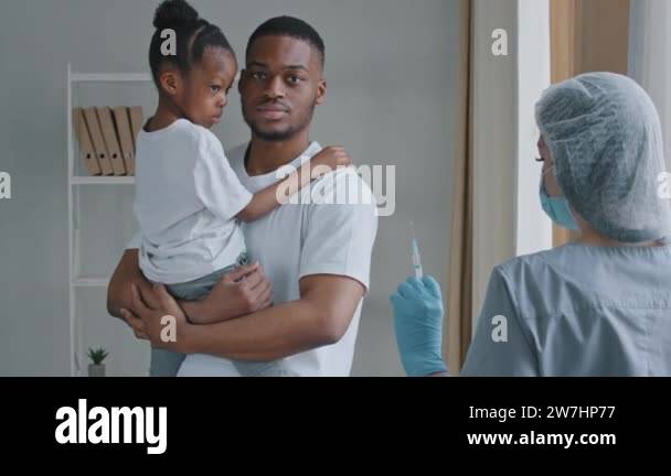 Young serious man afro american father holds in hands little African ...