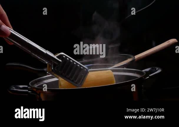 Cassava is being boiled in a pot of boiling water to making Thai ...