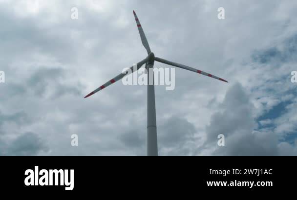 rotating blades of a windmill propeller on blue sky background with ...