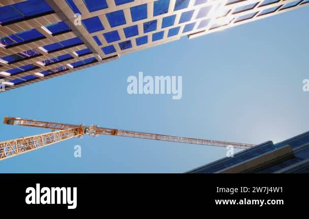 Construction of modern office buildings with glass facades. Bottom view ...