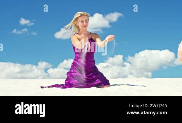Cinematic slow motion of a woman walking on a sand dune. Barefoot woman ...