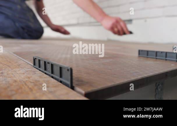 Carpenter sets spacing of deck boards on floor wood panel. Flooring ...