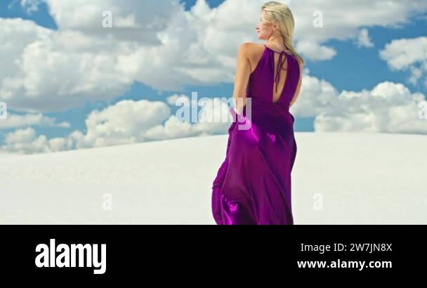 Cinematic slow motion of a woman walking on a sand dune. Barefoot woman ...