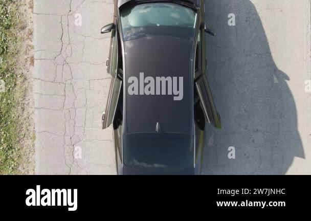 Slightly ajar doors of a passenger car are closed in turn, top view ...