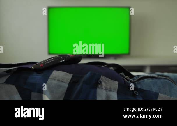 Man is asleep, the remote control from TV is lying on his stomach ...