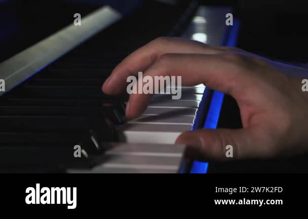 Musician plays piano during a live performance. right hand playing keys ...
