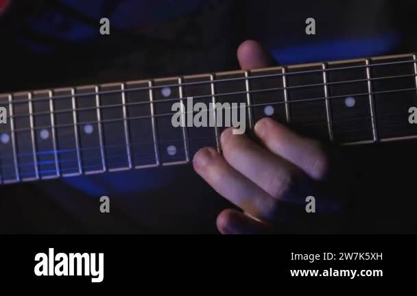 Changing chords and playing single keys. musician playing the guitar ...