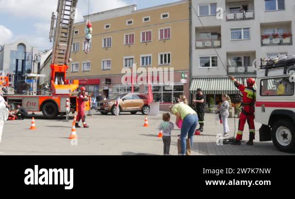 Firefighter is Pulling The Rope is Lifting Up the Child Man in Workwear ...