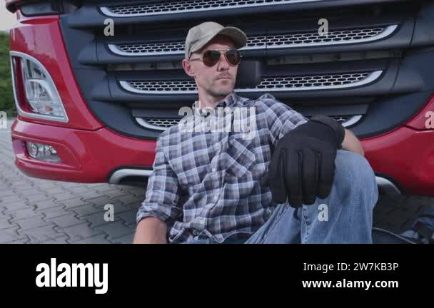 Semi Truck Male Driver Outside Of Vehicle Sitting On Ground Relaxing ...