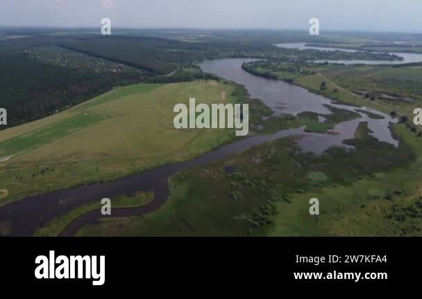 river in the field, green grass valley at river shore aerial. Nobody ...