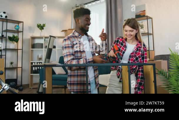 Handsome smiling skilful black-skinned guy is satisfied of work of his ...