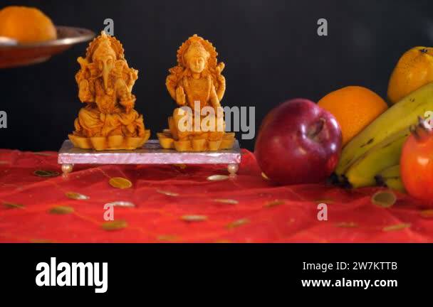 Pooja Thali with a Diya, marigold flowers, and sweets - Worshipping ...
