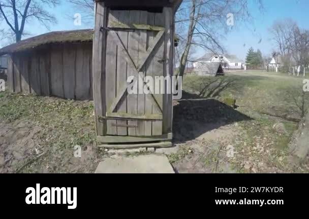 Rural wooden wc house in village. Walking into outdoor wc booth. Gimbal ...