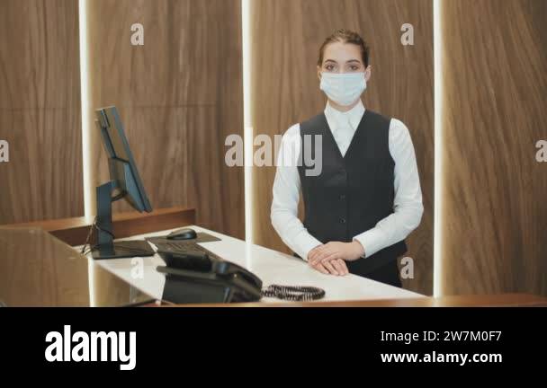 Medium slowmo portrait of female hotel receptionist wearing uniform and ...
