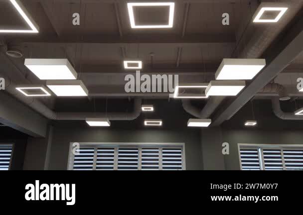 loft lighting of the room. different geometric shapes of office ceiling ...