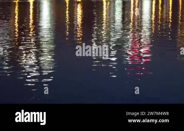 Water surface with city lights, blurred defocused light on the river ...