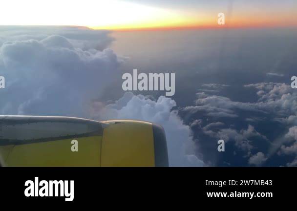 Airplane flight. Wing of an airplane flying above the clouds and sea in ...