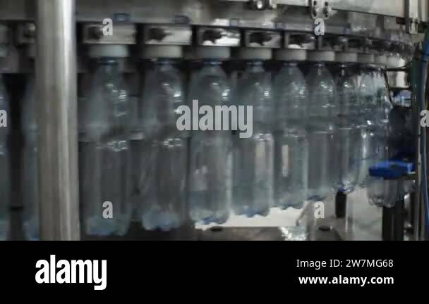 The process of automatic filling of water in a plastic bottle with a ...