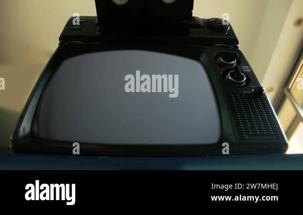 Male Hand inserting a VHS into a VCR and an Old TV with Green Screen ...