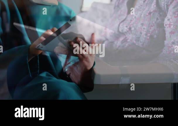Animation of female surgeon using digital tablet over crying senior ...