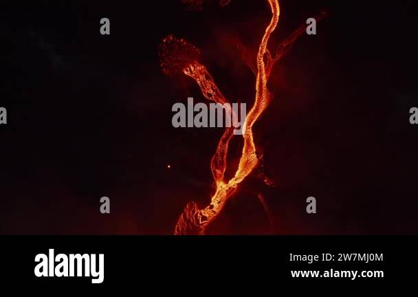 Aerial birds eye overhead top down panning view of flowing hot lava ...