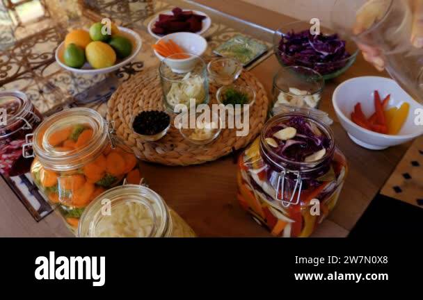 Fermenting, preserving vegetables, finishing a jar by adding water with ...