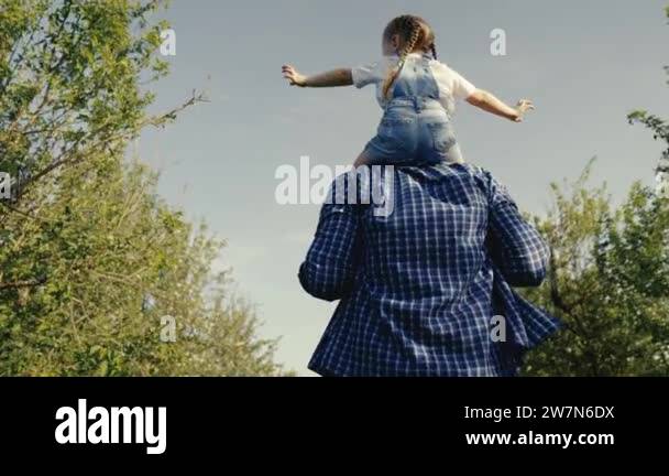 A happy family. Father walks with baby, baby dreams of becoming pilot ...