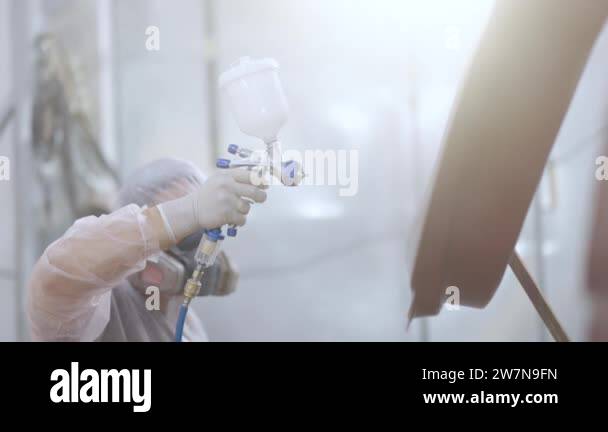 Painting Spray Paint vehicle parts at car service workshop. Industrial ...