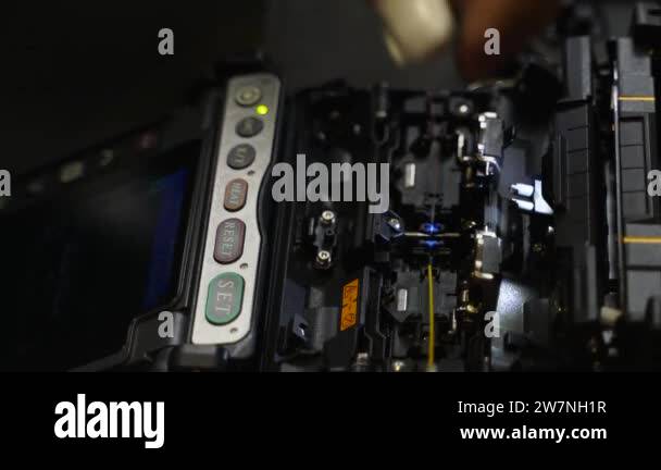 Worker welds optical line internet wire with welding machine. Service ...