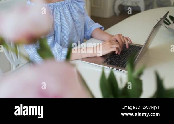 Female freelancer typing text on the laptop keyboard. Working in modern ...