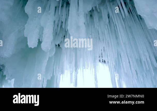 Inside the ice cave, the white translucent icicles of different ...