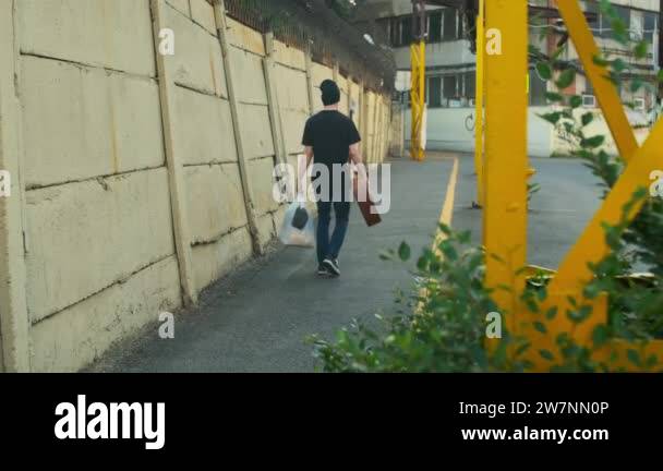 Homeless man with belongings on the street going anywhere along the ...