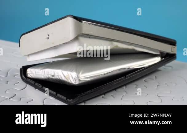 Swollen bad damage battery cell of powerbank on top of jigsaw puzzle ...