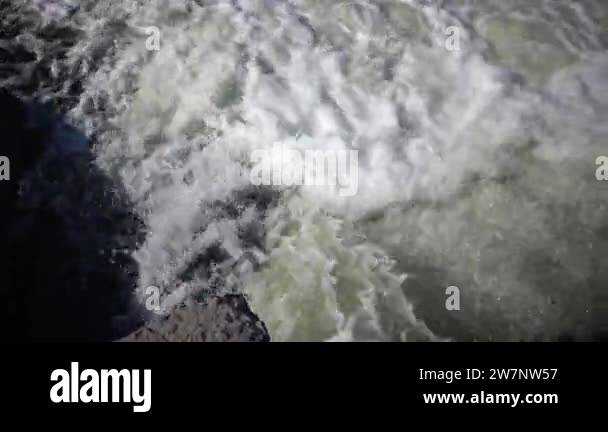 Water pollution. Dirty water from treatment plants flows through a pipe ...