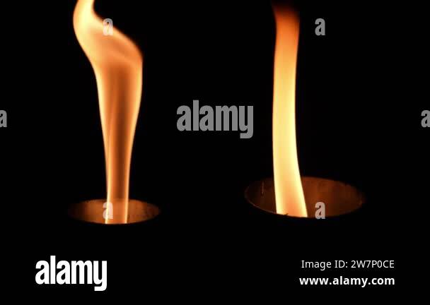 Two isolated fire flames, slow motion gas ignition from bottom to top ...