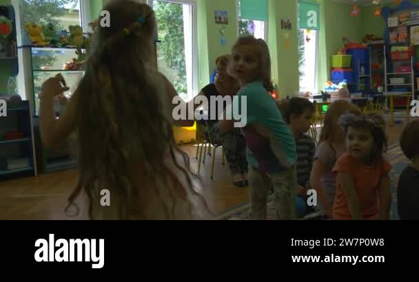 Girls are Playing Turning around Blonde Haired Girl with Long Hairs ...