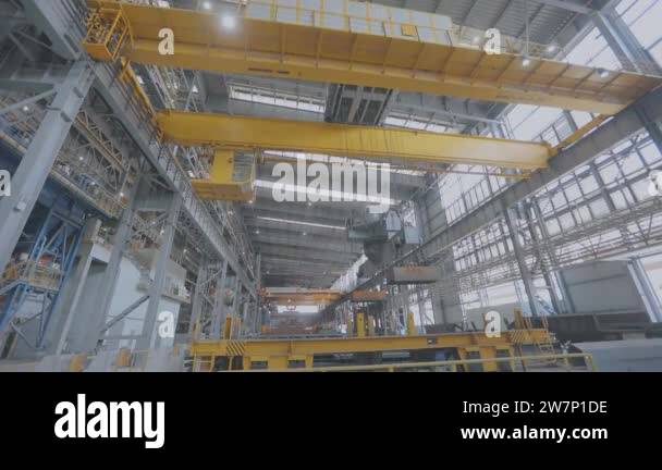 Yellow overhead crane with an electromagnet. A yellow bridge crane with ...