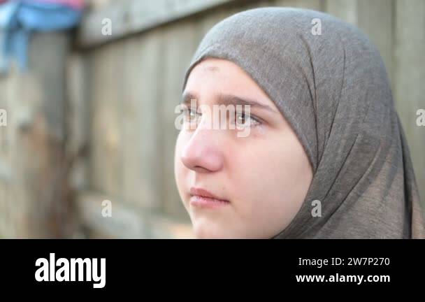 A Teenage Refugee Girl Is Crying And Screaming Holding Her Head In Her