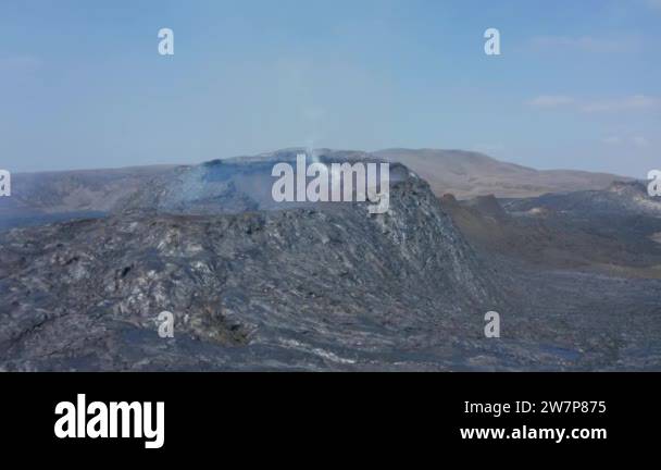 Fagradalsfjall volcano, aerial drone flying towards smoky fissure cone ...