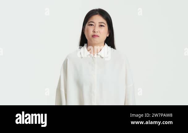 Frustrated asian korean woman clapping her hands standing isolated over ...