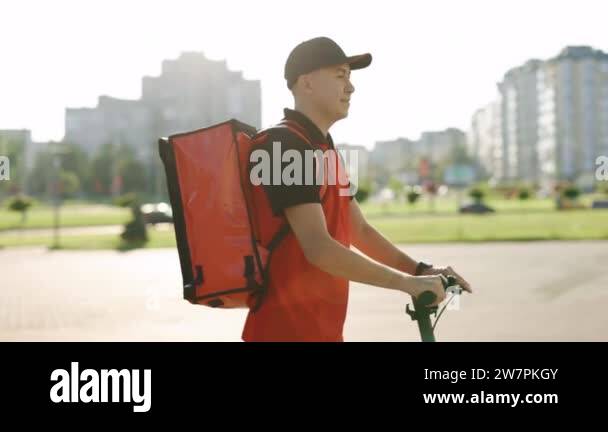 Male deliverman courier with isothermal backpack case pizza box rides ...