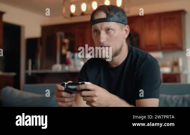 A determined male gamer who experiences emotional stress when he plays ...