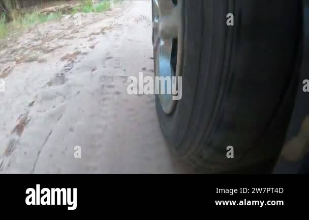 Filming of a car driving off-road. The camera shoots the wheel, taking ...