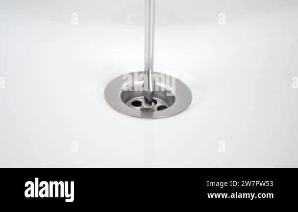 Plumbing the sink with a screwdriver. Screwing in and fixing the ...