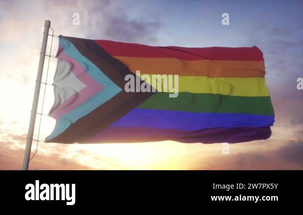 Progress LGBT flag waving in the wind, sky and sun background. LGBT ...